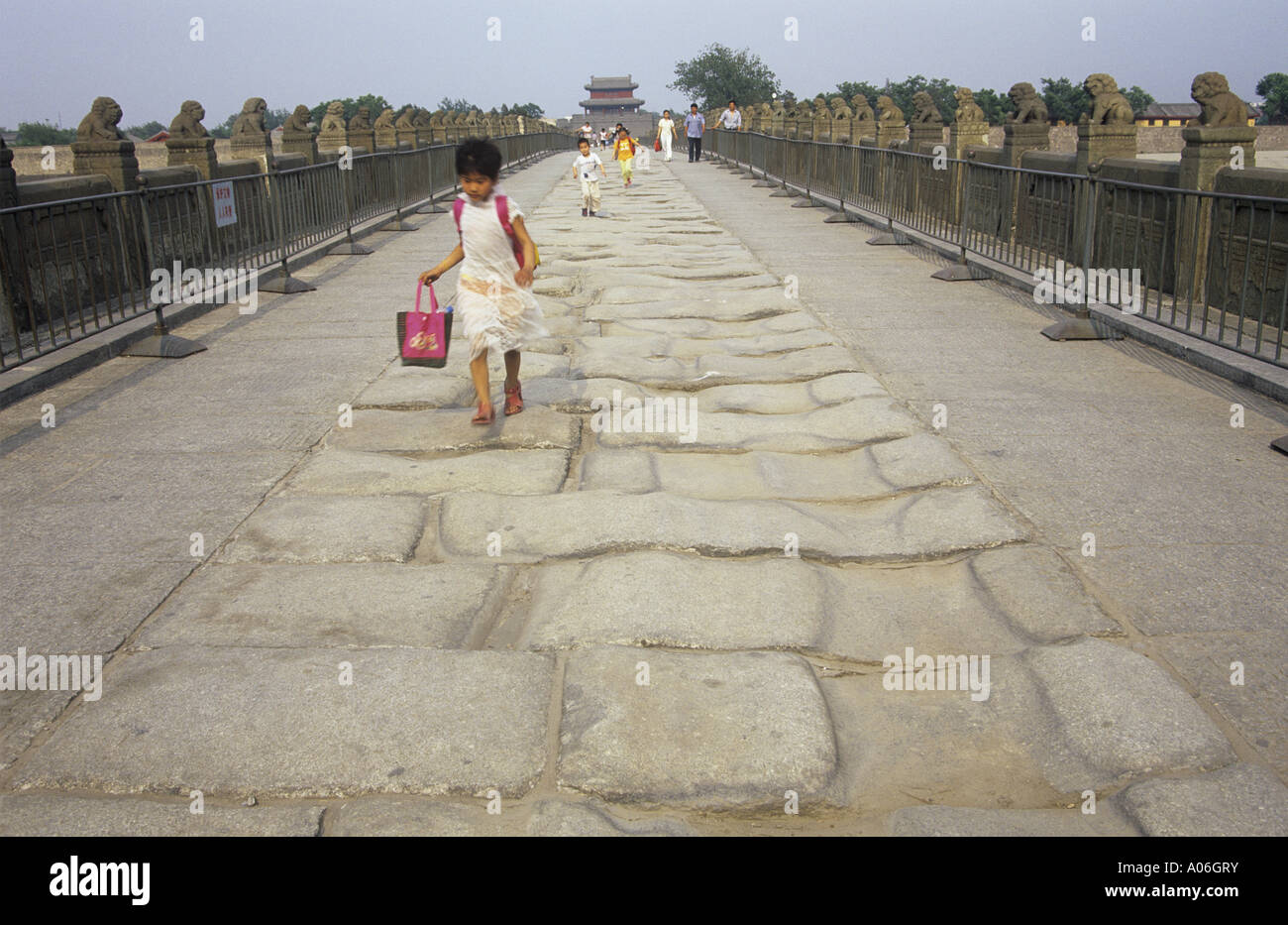 People walking across Marco Polo bridge Lugouqiao a marble bridge with ...