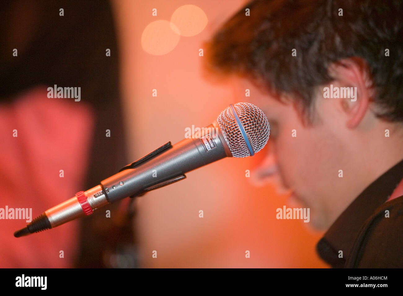 a singer using a microphone Stock Photo - Alamy