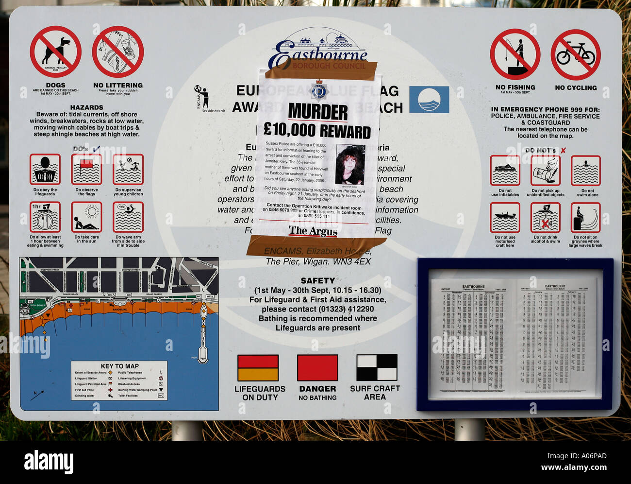 Wanted for murder poster on seaside holiday information sign Stock ...