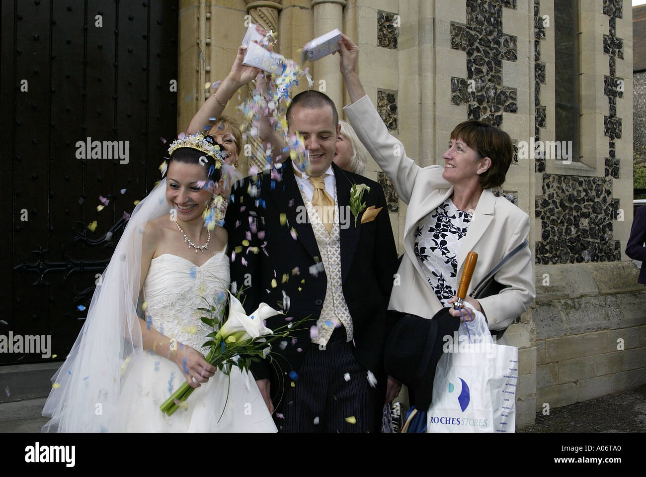 Bride and groom at uk wedding with guests throwing confetti Stock Photo ...