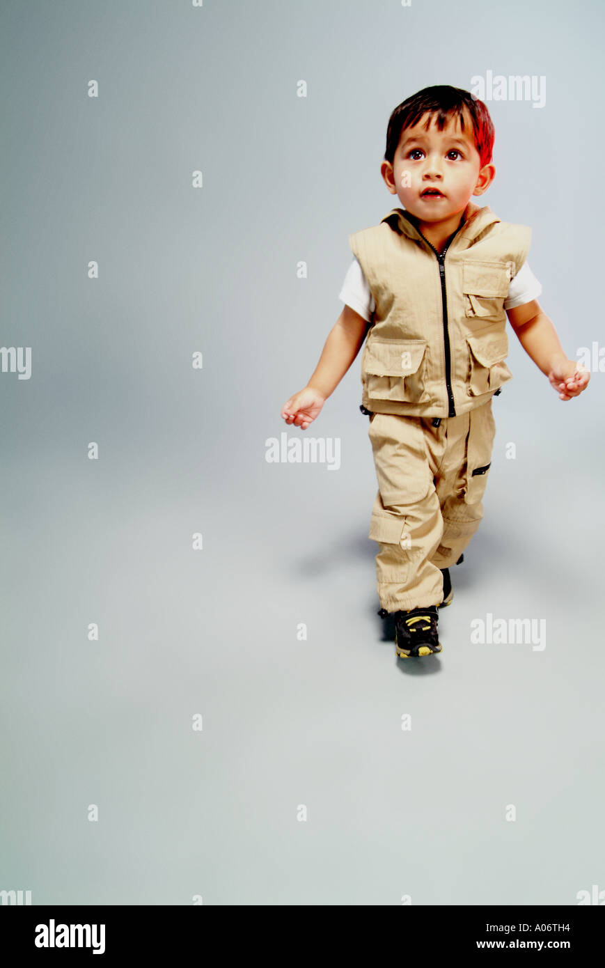 Young boy walking towards camera Stock Photo - Alamy