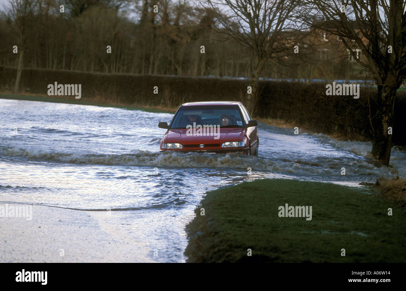 Car driving through water on a flooded road Stock Photo - Alamy