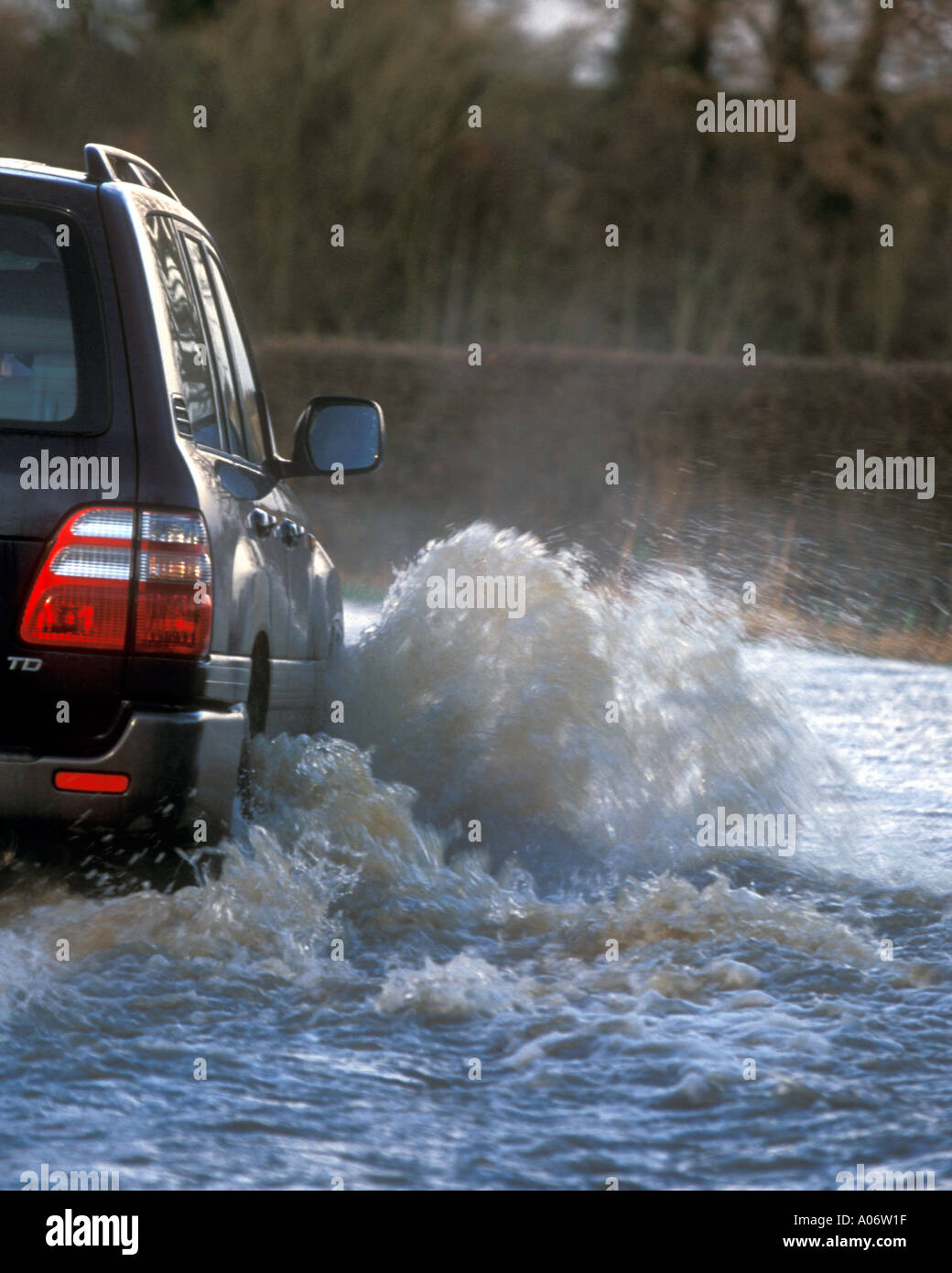 A four wheel drive vehicle going through water on a flooded road Stock ...