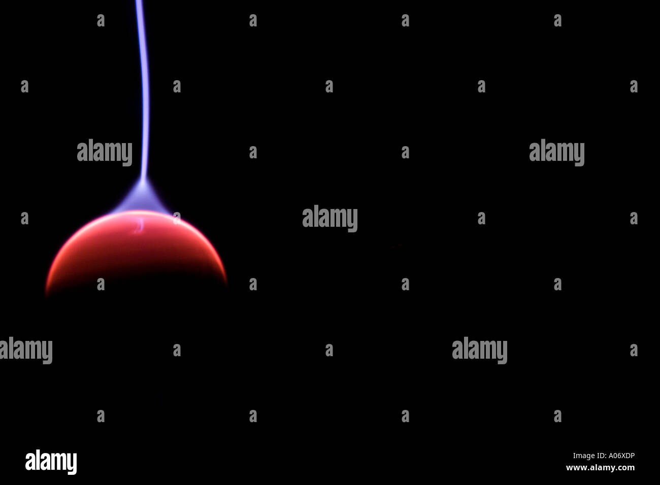 Single stream of plasma from plasma globe against black background ...