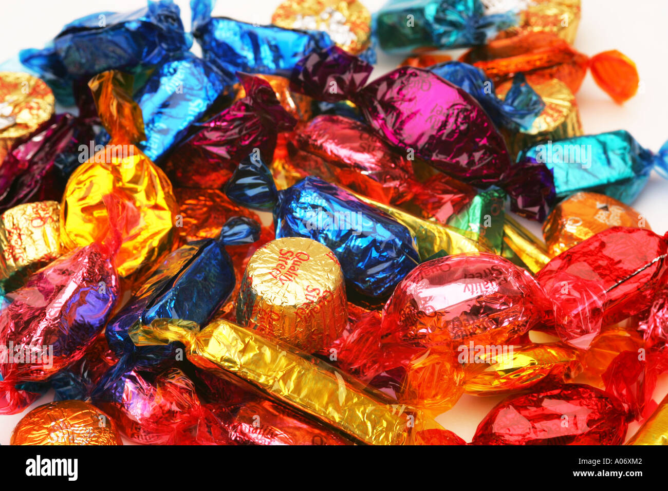 Closeup detail of assorted brightly coloured chocolates sweets candy in ...