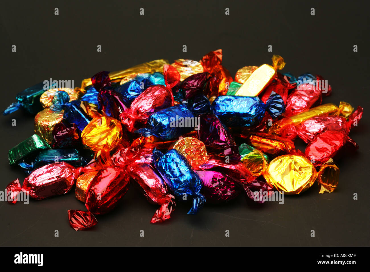 Closeup detail of assorted brightly coloured chocolates sweets candy in ...