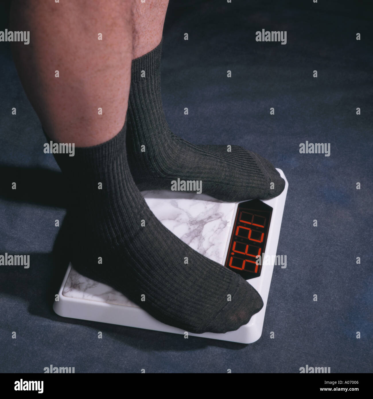 A man standing on Bathroom Scales Stock Photo - Alamy