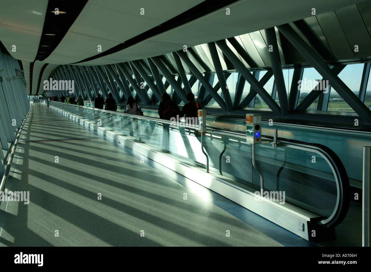 Passengers walking acccross new passenger walkway bridge to aircraft ...