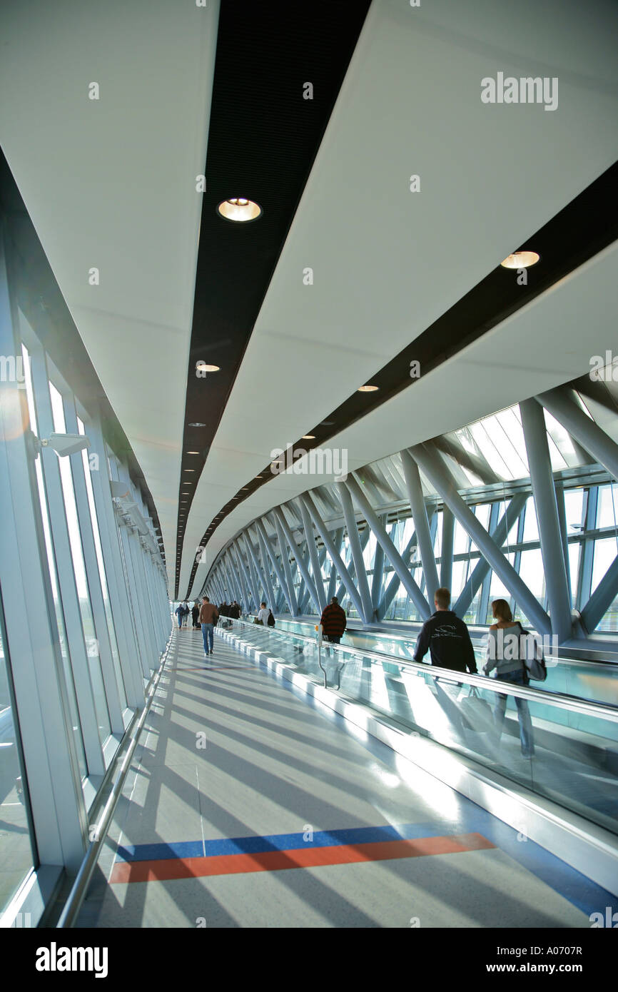 Passengers walking acccross new passenger walkway bridge to aircraft ...