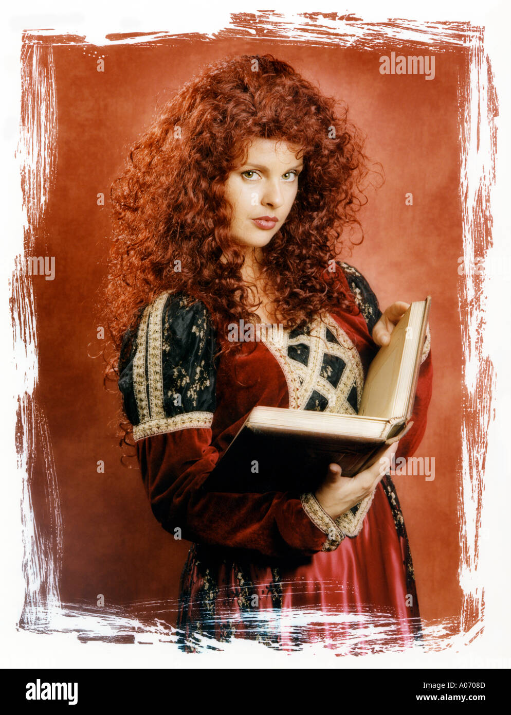 Reading the Almanac. Girl in an Elizabethan Dress Reading a Book Stock ...