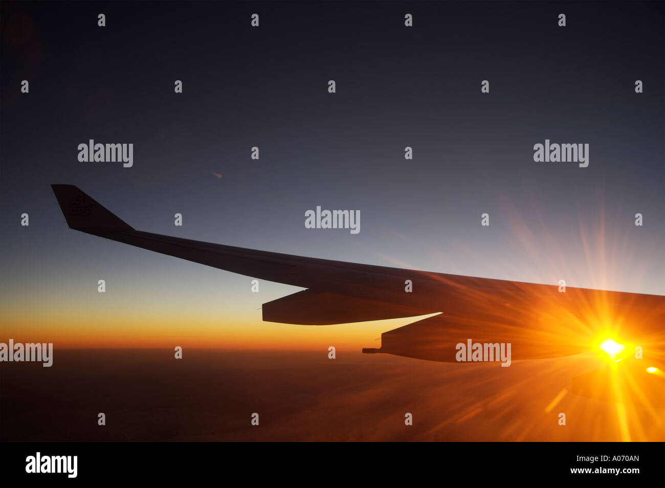 dramatic sunset and dusk as seen from an airplane window over the ...