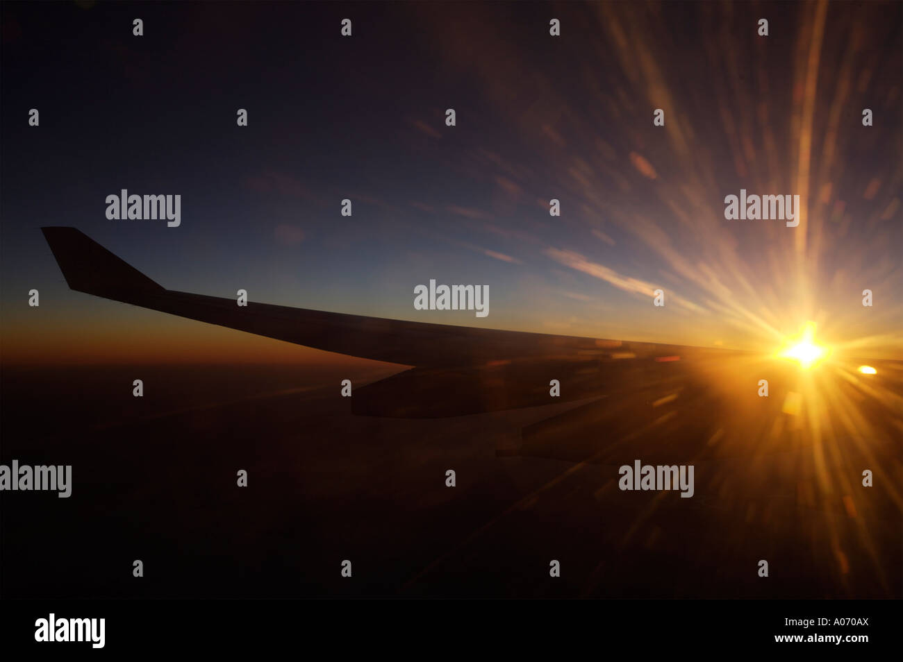 dramatic sunset and dusk as seen from an airplane window over the ...