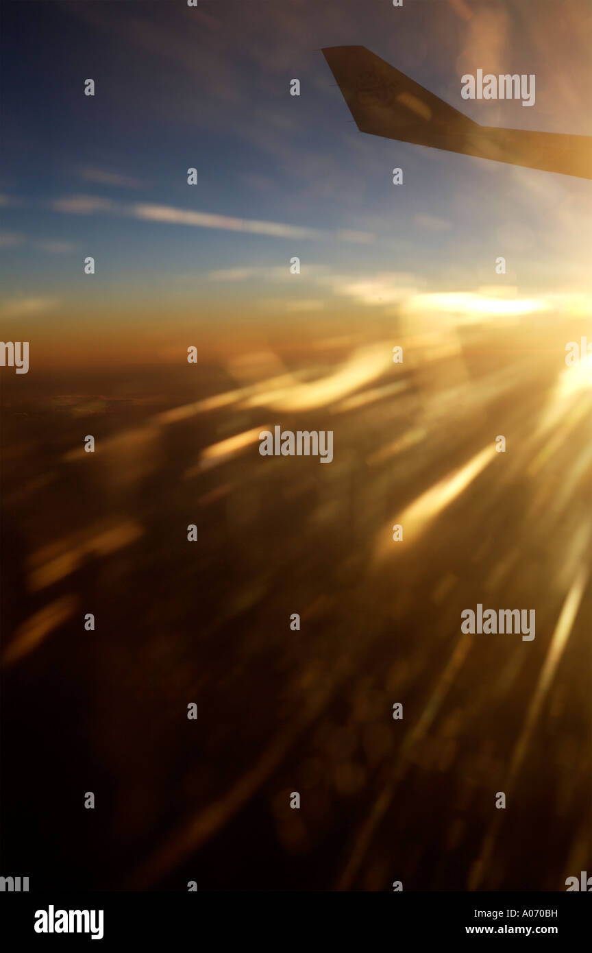 dramatic sunset and dusk as seen from an airplane window over the ...