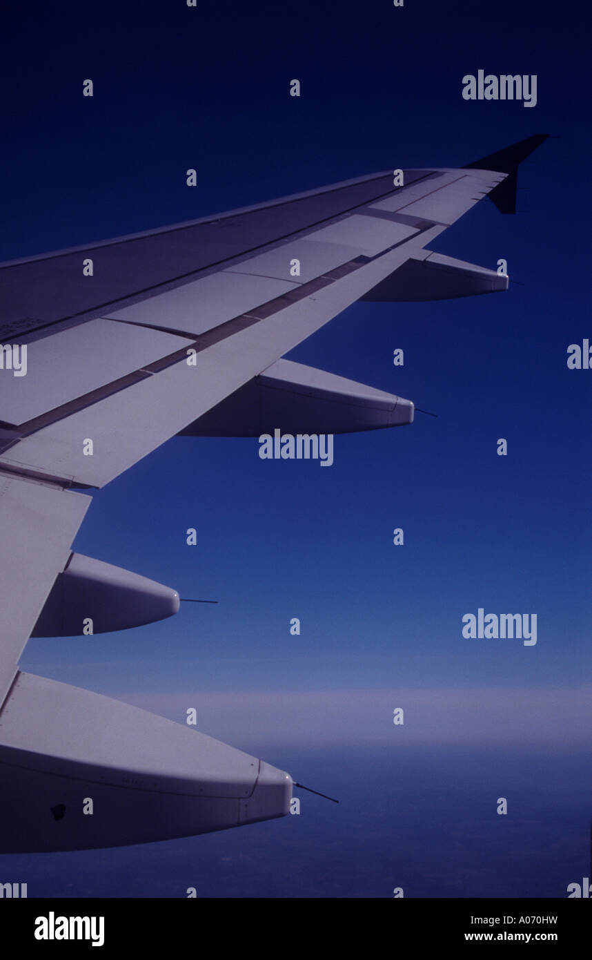 graphic angle of airplane wing over a deep blue sky in flight Stock ...