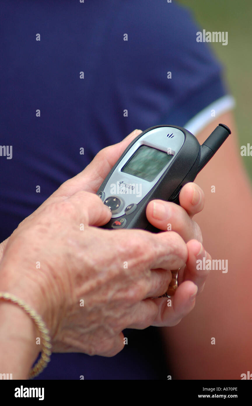 Senior Woman with old style flip phone, cell phone in use Stock Photo ...