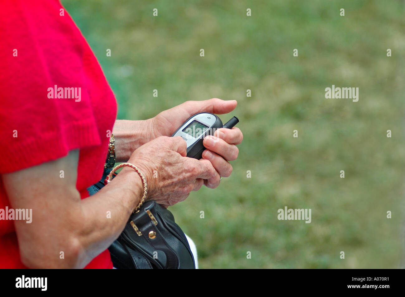 Senior Woman with old style flip phone, cell phone in use Stock Photo ...