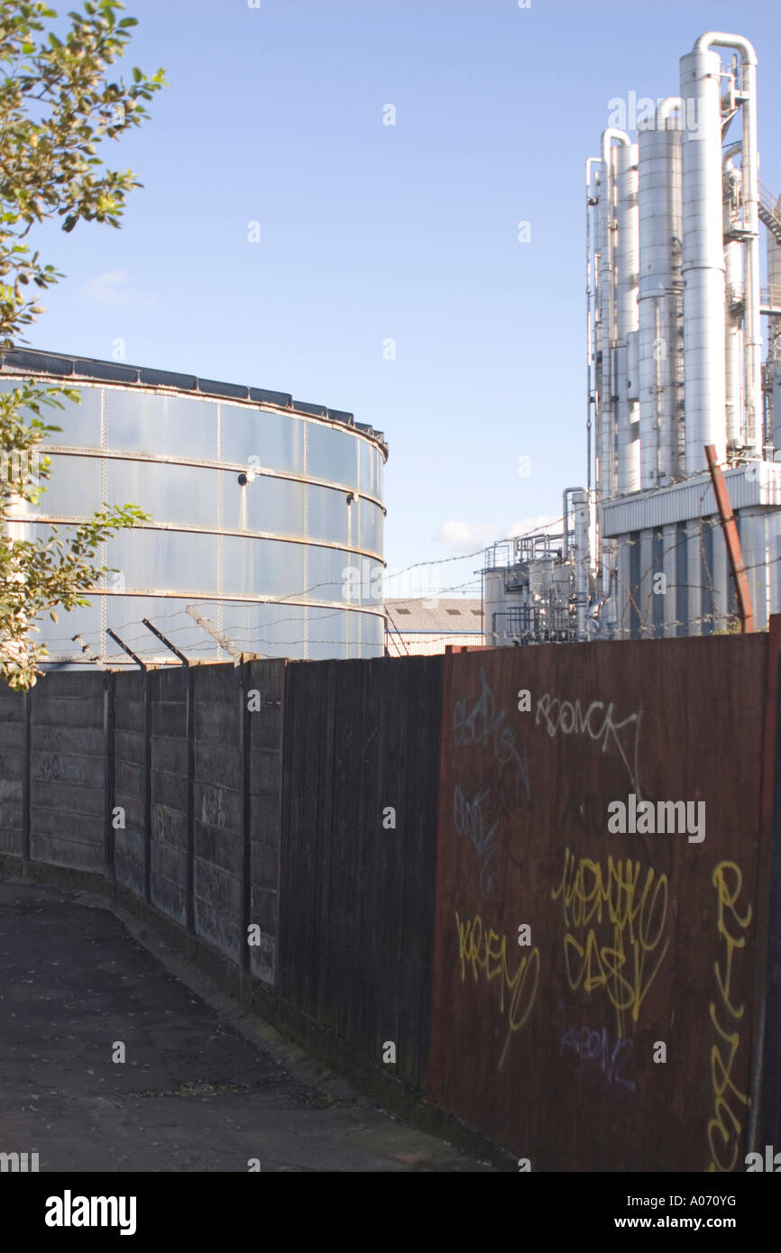 steel tanks of factory works, behind high rise barbed wire security ...