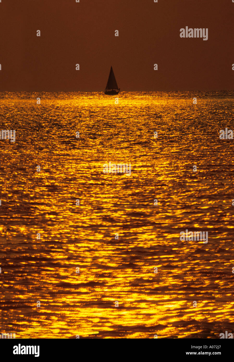 Yacht sailing in sunset with reflections on water Florida Keys USA ...