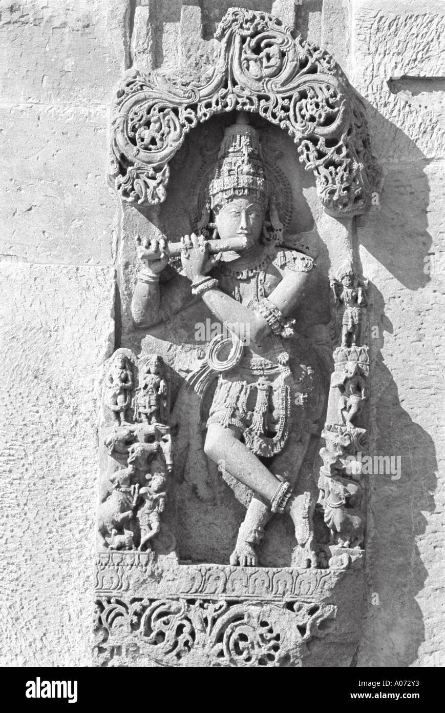 Lord Krishna playing flute on Halebid temple Karnataka India Stock ...