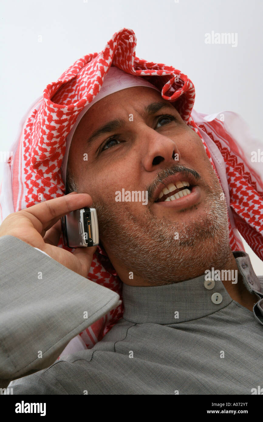 arab man on mobile phone wearing dish dash headwear in kuwait middle ...