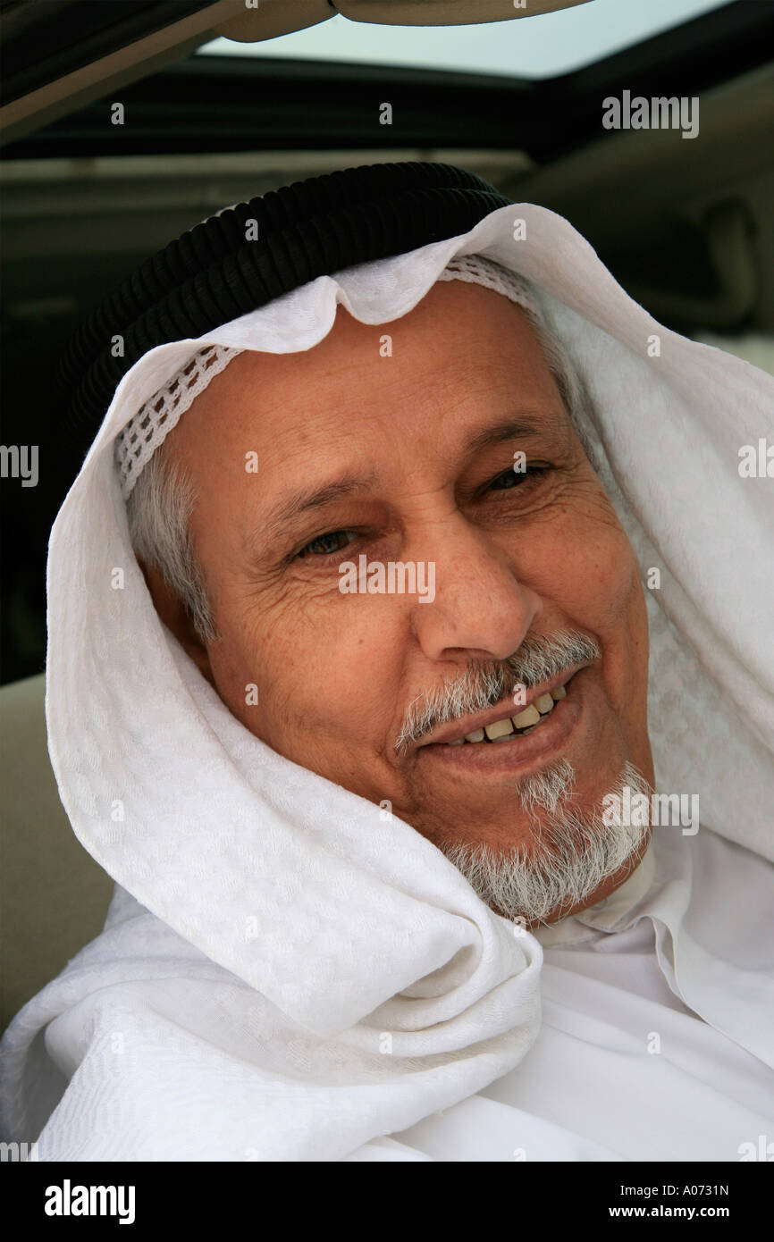 happy old arab man smiling at camera in dish dash in kuwait middle east ...