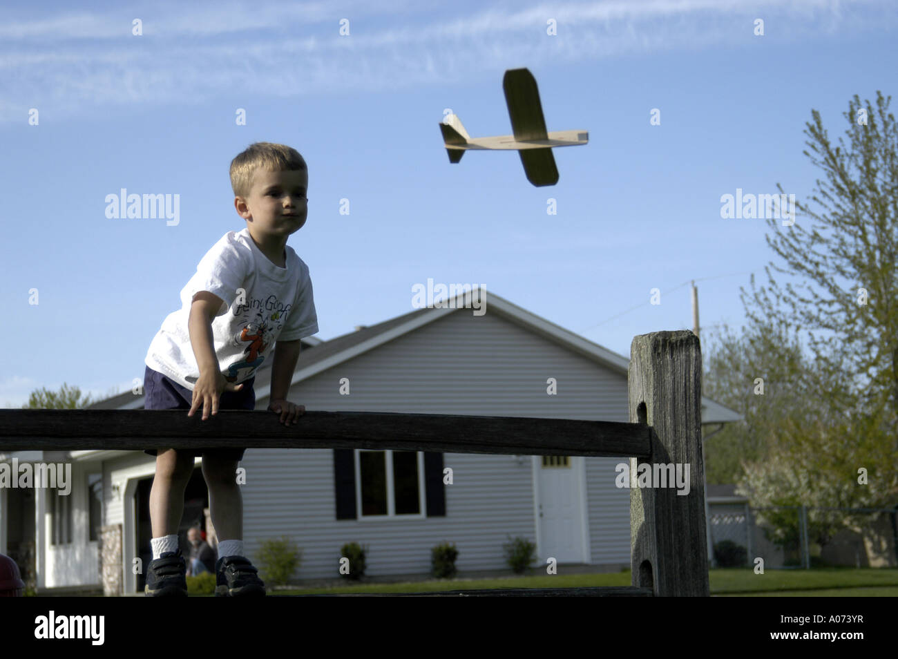 4 year old caucasian boy flies balsa wood glider Stock Photo - Alamy