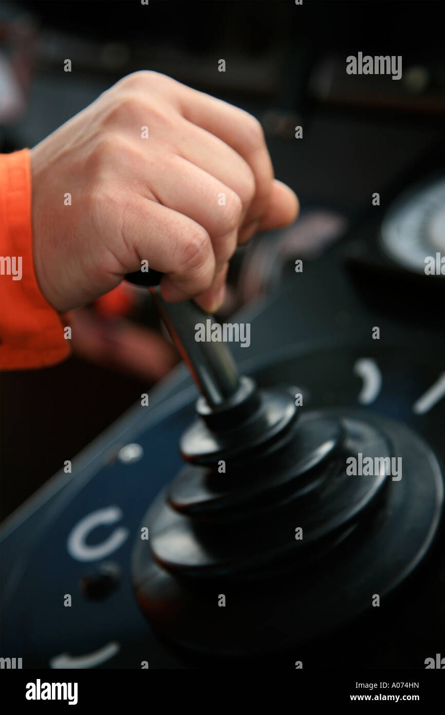 Graphic Shot Of Tugboat Captain Using Controls Whilst Manoevering By Containership In Kwai Chung