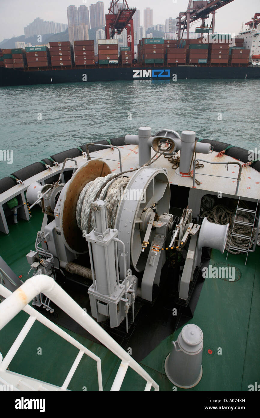 Tugboat manoevering in Kwai Chung by a container ship in Container Port ...