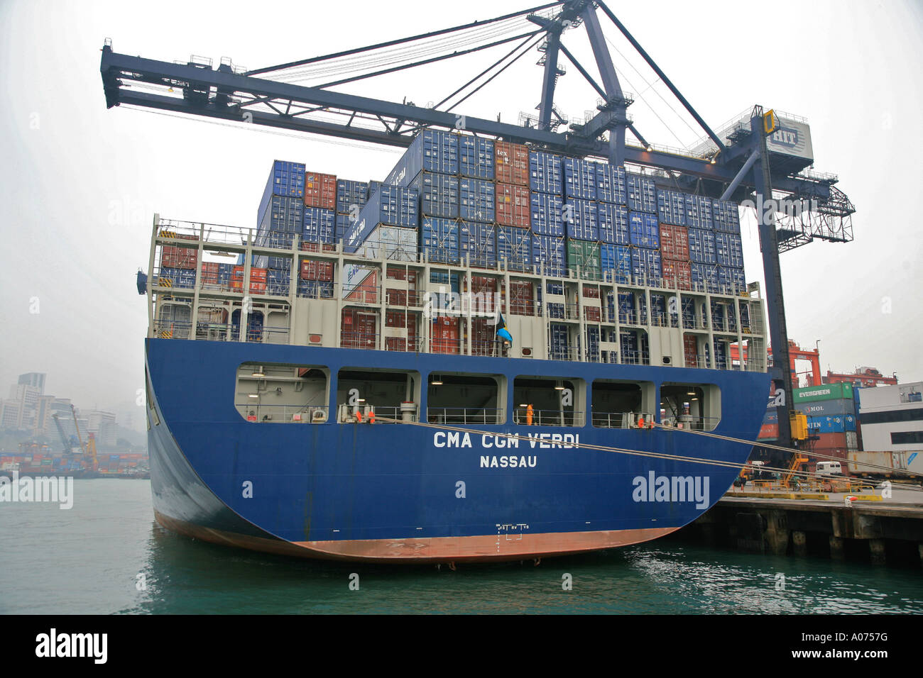 Graphic angle shot of containership at quayside with crames overhead in ...