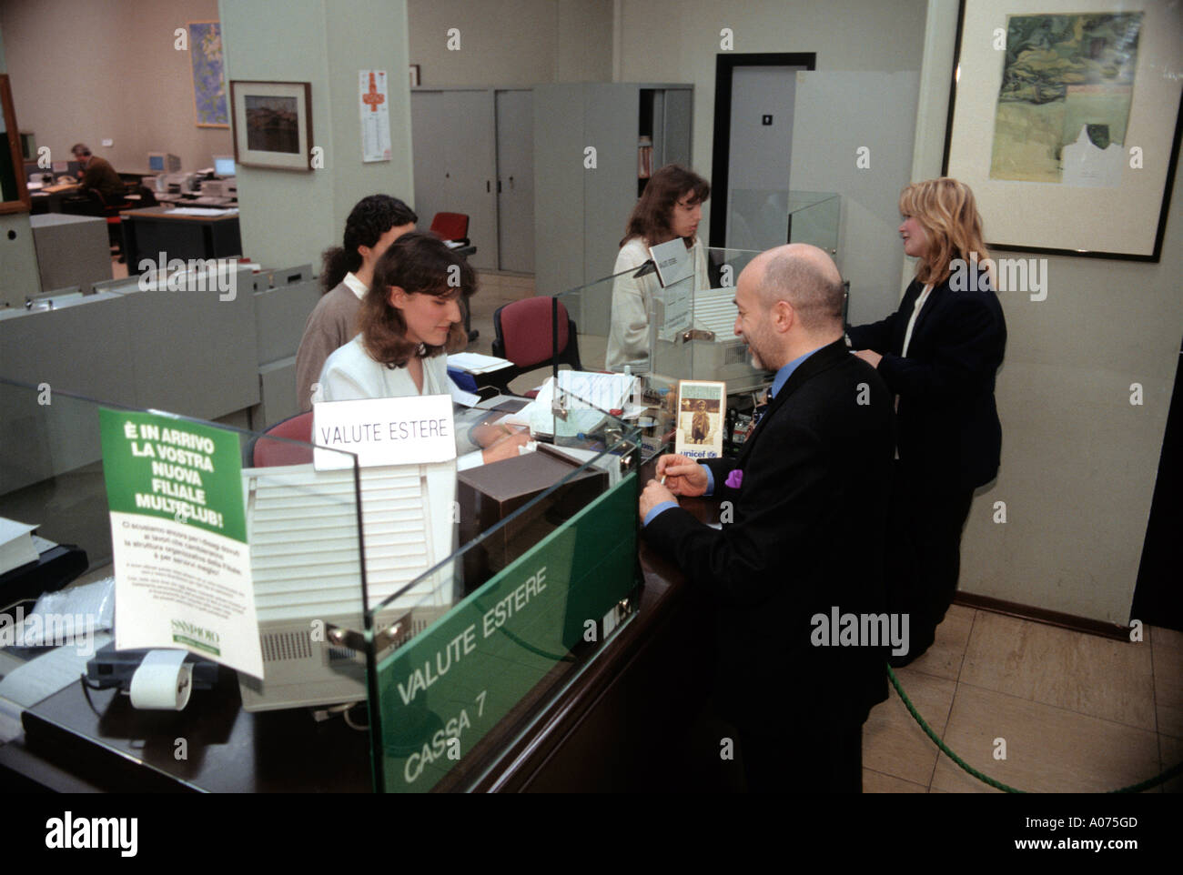 Tellers and customers inside of a bank in Turino, Italy Stock Photo - Alamy