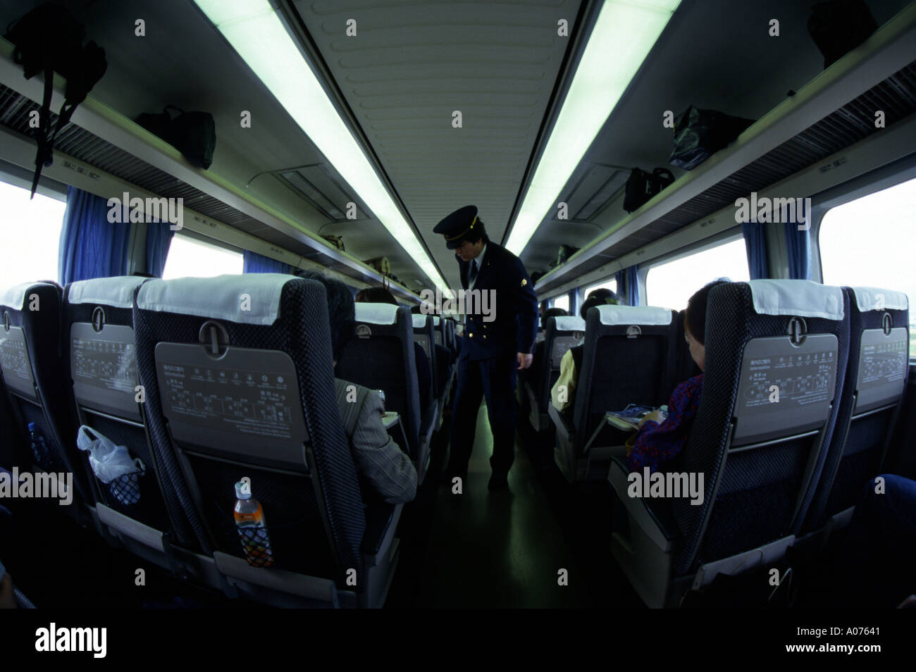 A ticket collector checks tickets on Japan`s Bullet Train Stock Photo ...