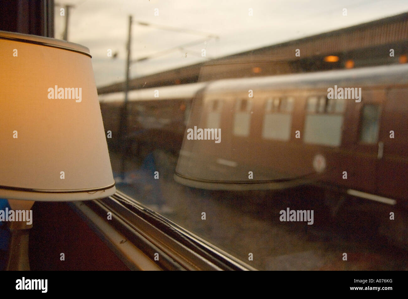 Interior of Pullman dining coach with lamp shade looking out of window ...