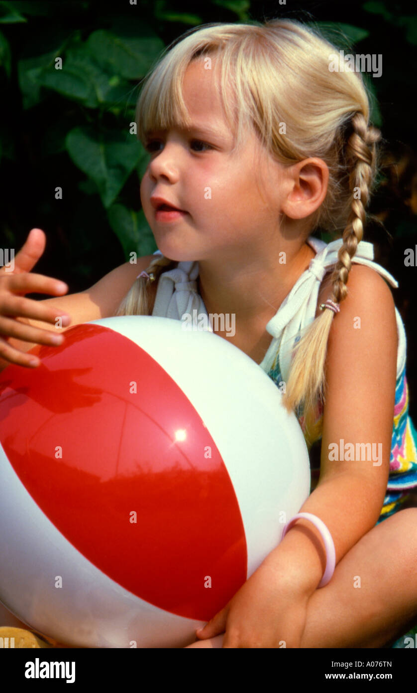 Child holding a large plastic ball Stock Photo - Alamy