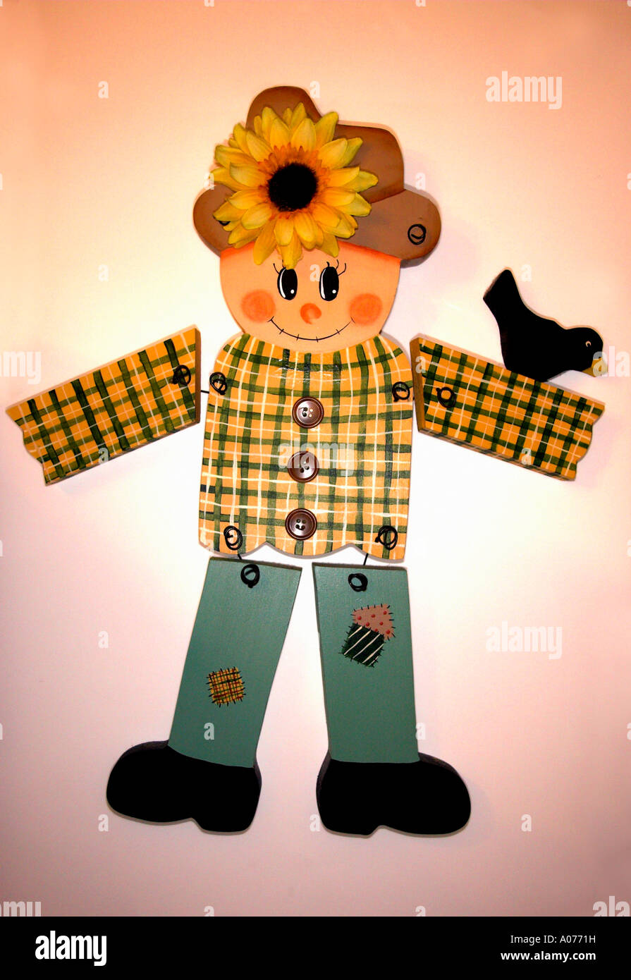 Wooden model of a friendly scarecrow Stock Photo - Alamy