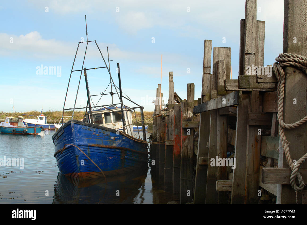 Old boat moored alongside an old wooden jetty River Tees Teesmouth ...