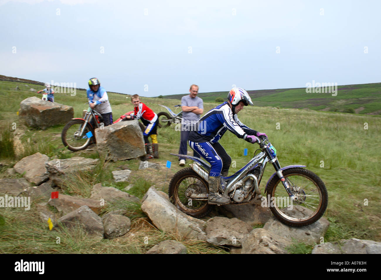 Motorcycle trials rider moving through and negotiating obstacles at ...