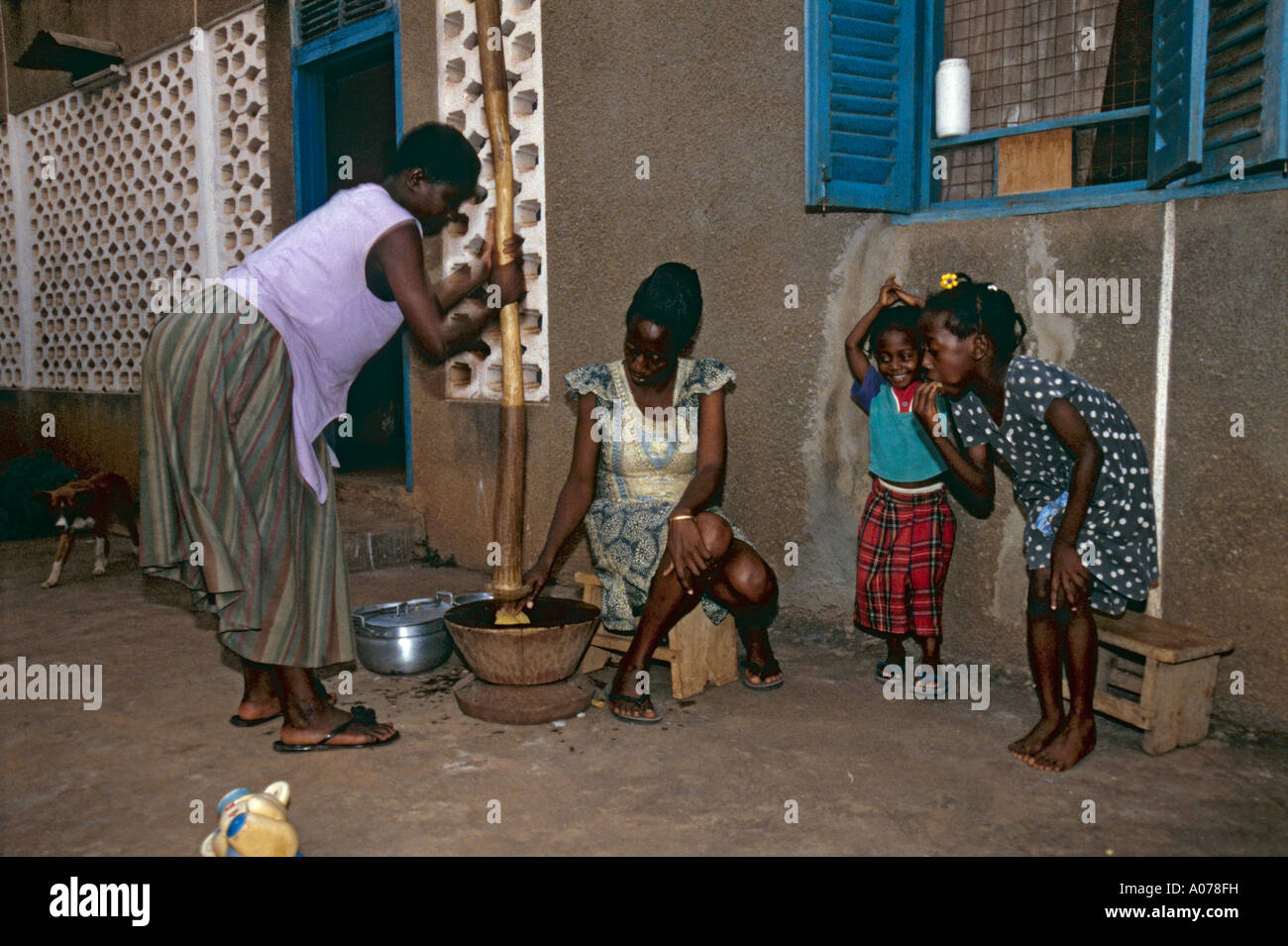 two women preparing fufu young girls watching Kumasi, Ghana, West ...