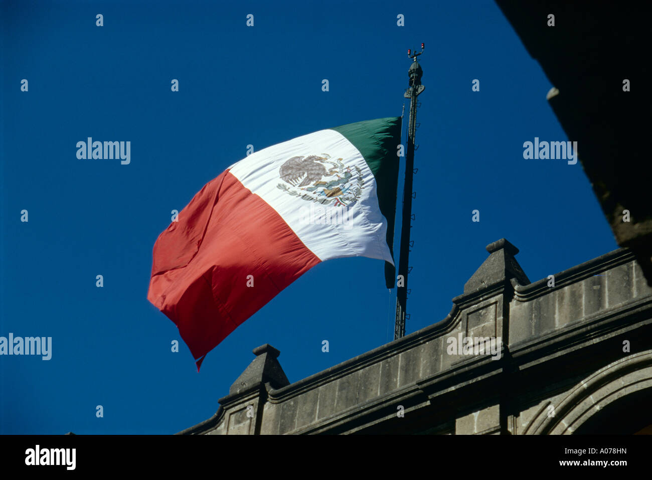 mexican flag flying over goverment building Stock Photo - Alamy