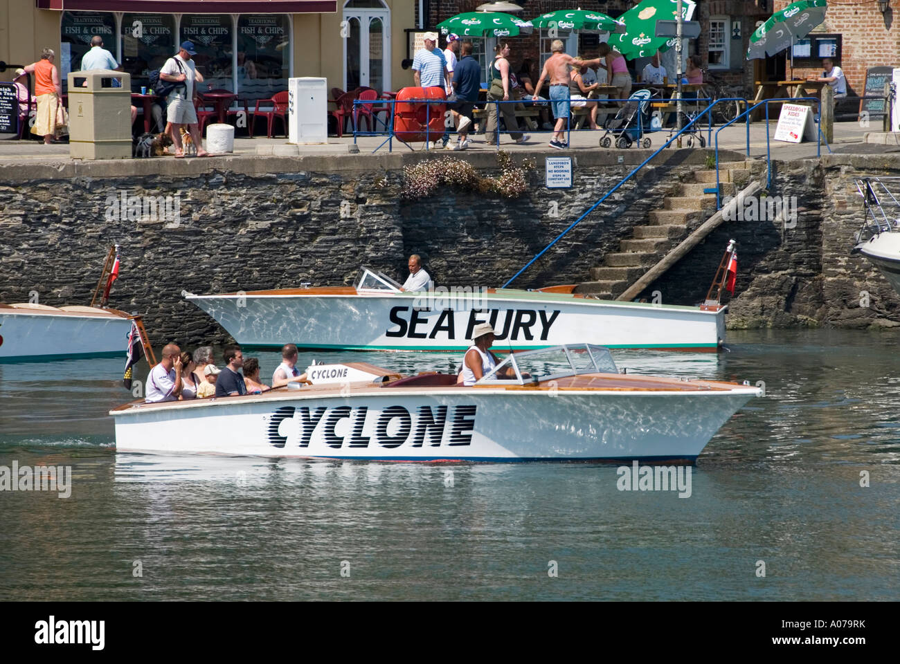 Speedboat departing quayside at Padstow harbour Cornwall England UK ...
