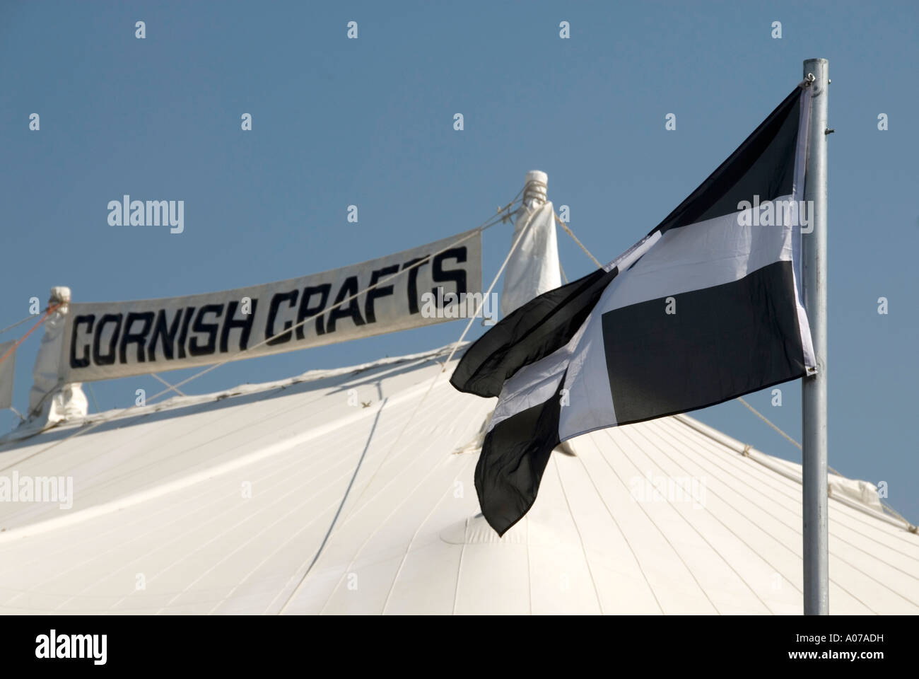 Flag of St Piran patron saint of miners above Cornish Crafts marquee ...