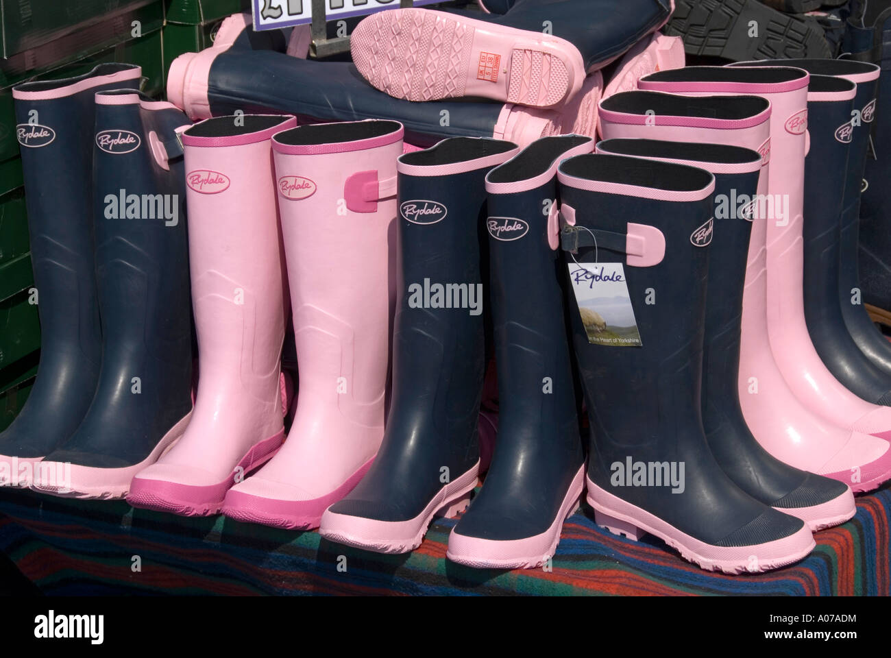 Wellington boots stacked on stand for sale at rural outdoor event Stock ...