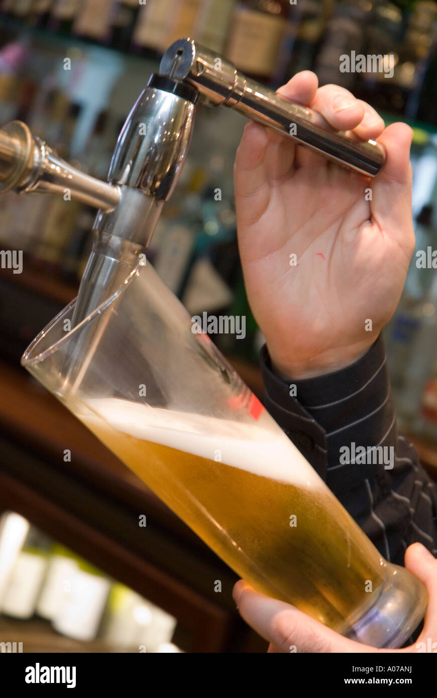 Close up of a man pouring a pint of draft lager Stock Photo - Alamy