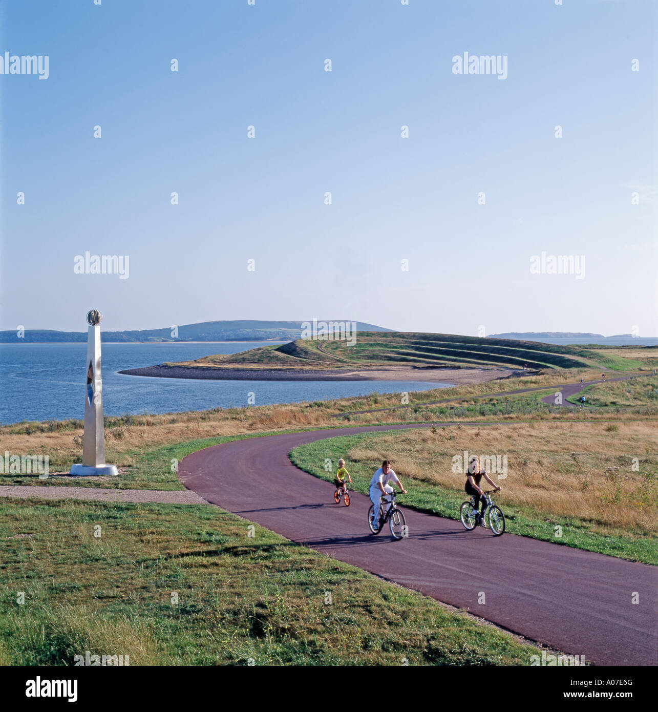 Family of cyclists riding bikes along the Millennium Coastal Path in ...