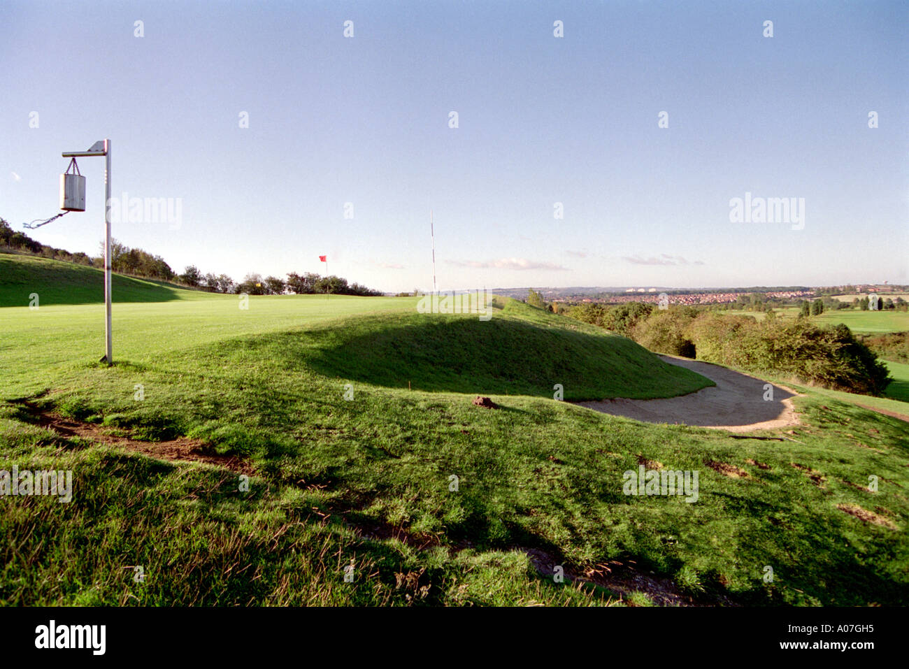 Golf course ,early morning scene. Windy day. Greenside bell ringing in ...