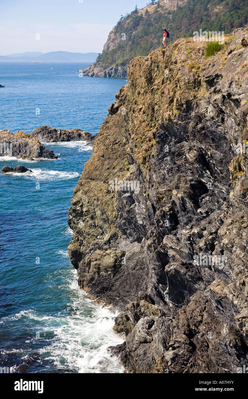 Woman on cliffs looking over Puget Sound Deception Pass state park ...