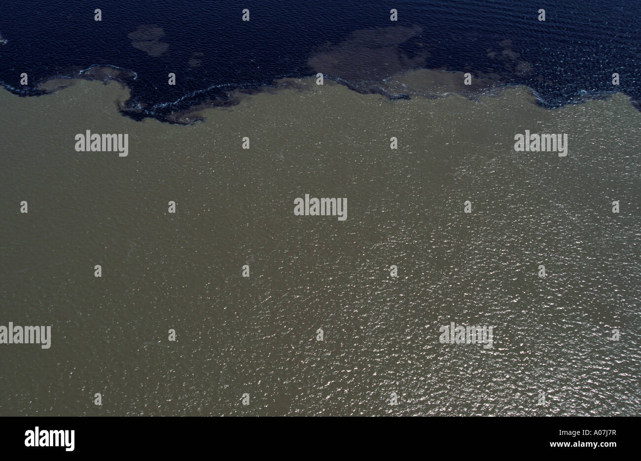 Meeting of the Amazonas river waters and Negro river waters, near ...