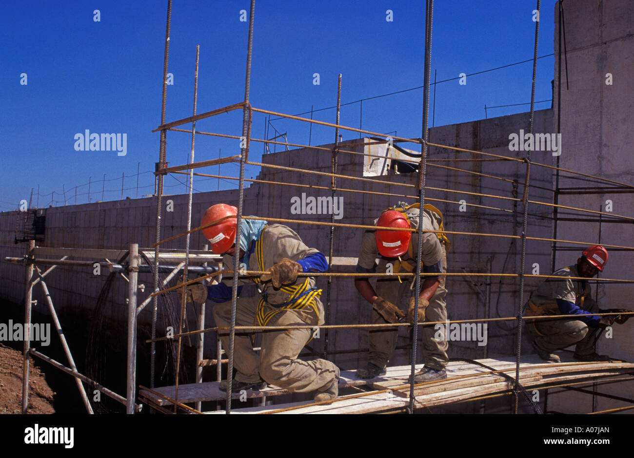 Construction workers using safety gears: helmet, glove, uniform ...