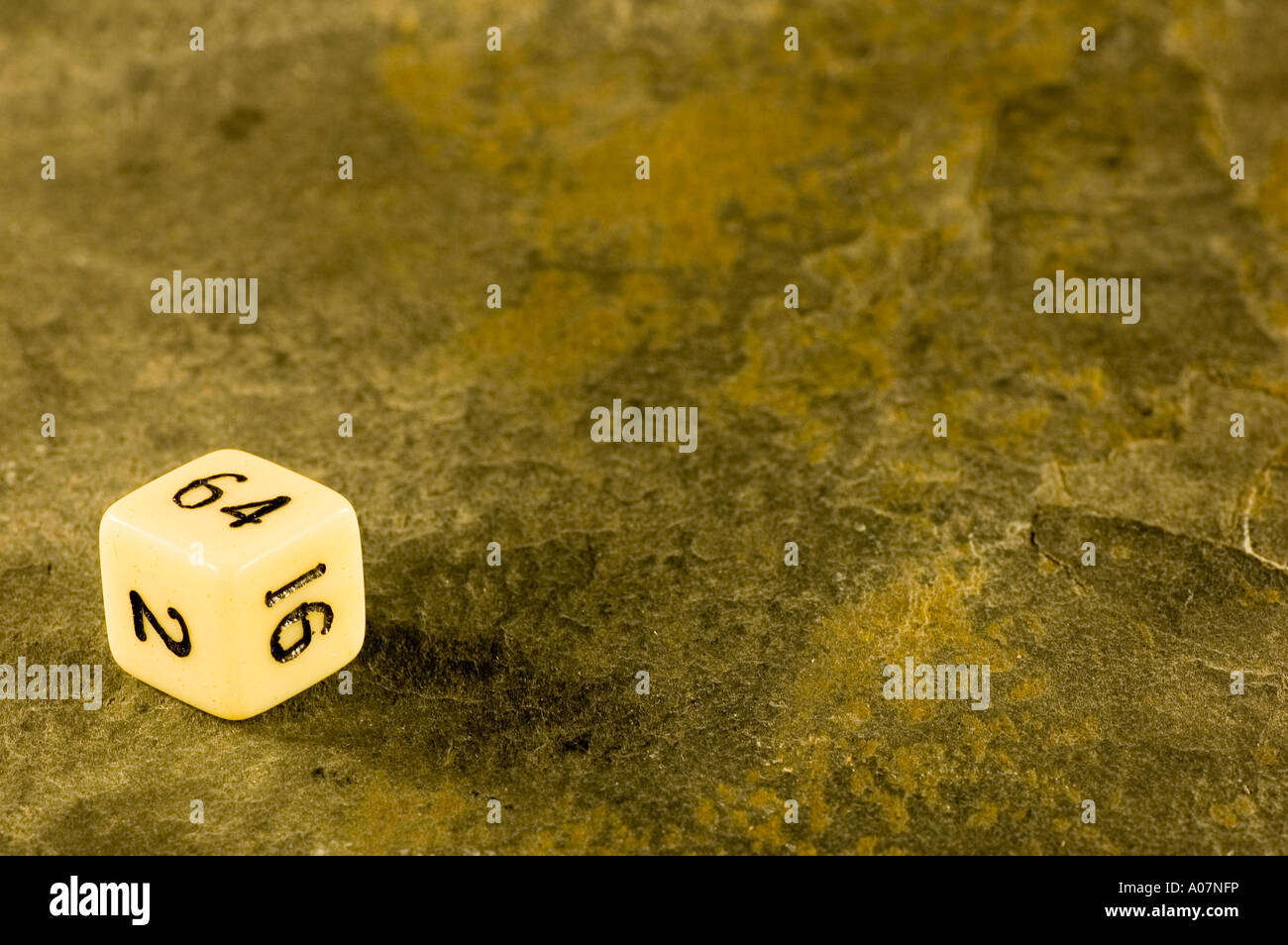 Single Dice on Slate Base Stock Photo - Alamy