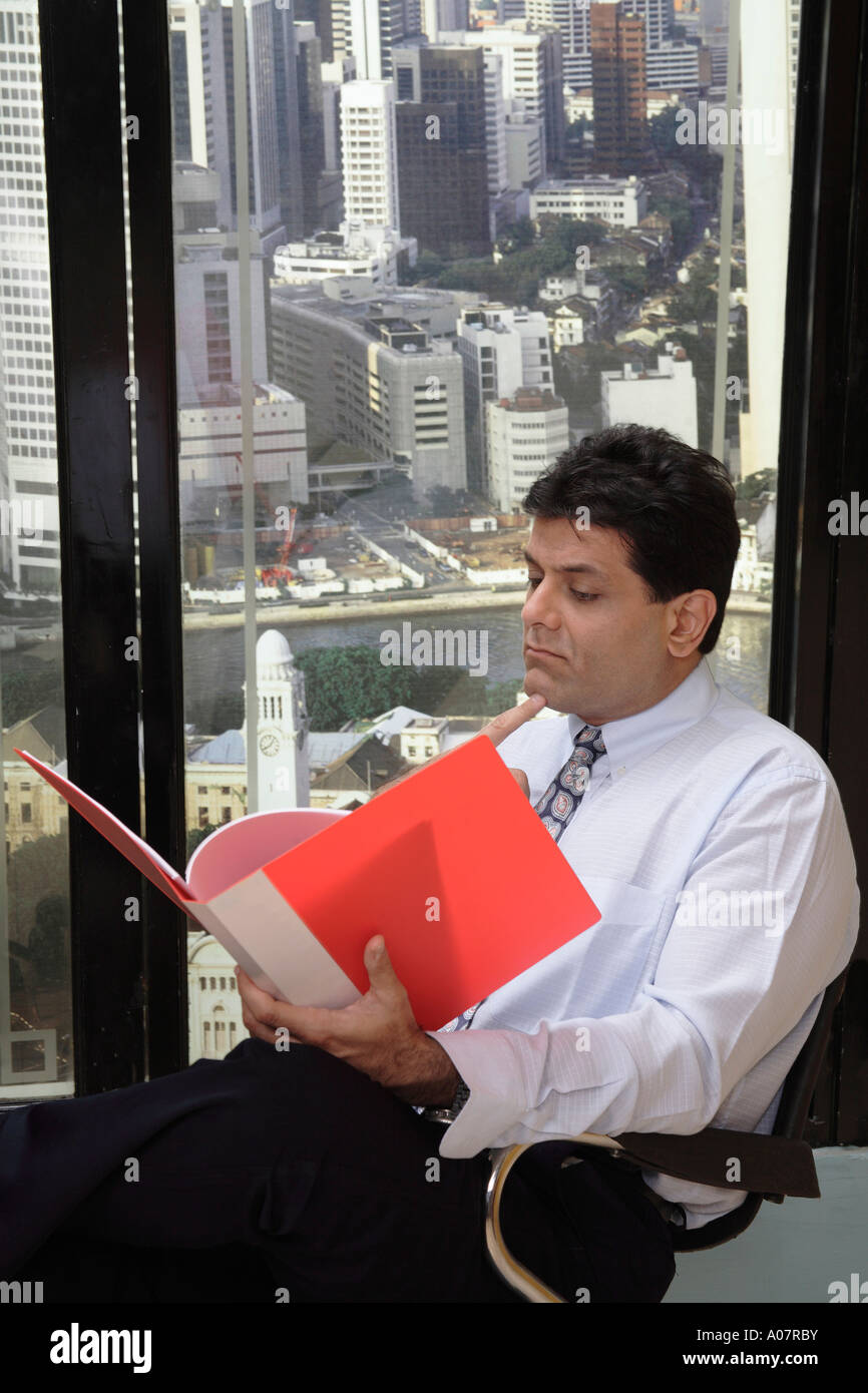 CEO reading report in his cabin with city background Stock Photo - Alamy
