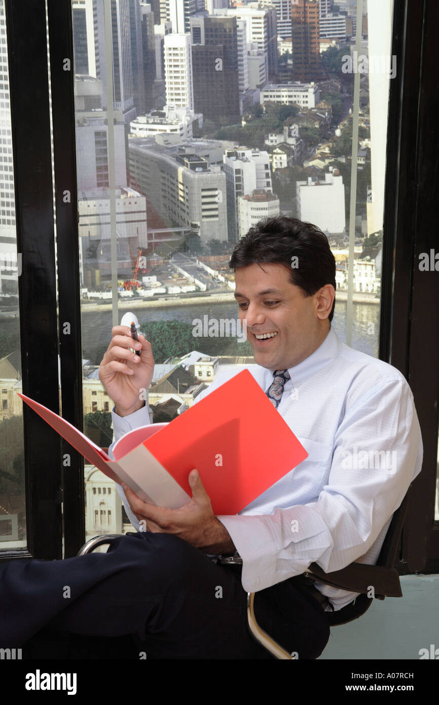 CEO reading report in his cabin with city background Stock Photo - Alamy